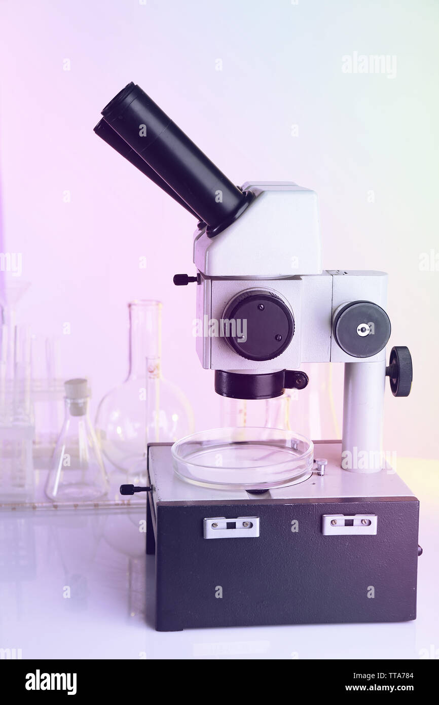 Test tubes and microscope on bright background Stock Photo - Alamy