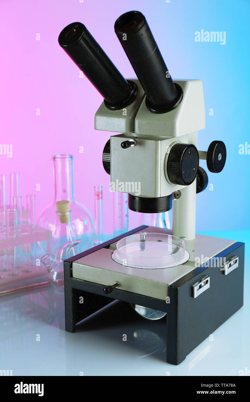 Test tubes and microscope on bright background Stock Photo - Alamy