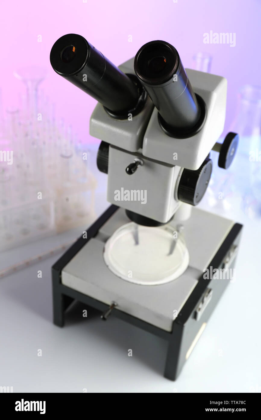 Test tubes and microscope on bright background Stock Photo - Alamy