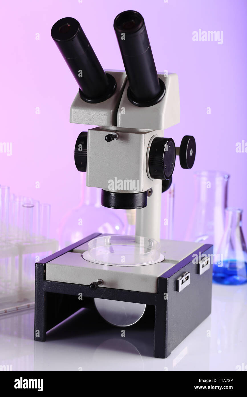 Test tubes and microscope on bright background Stock Photo - Alamy