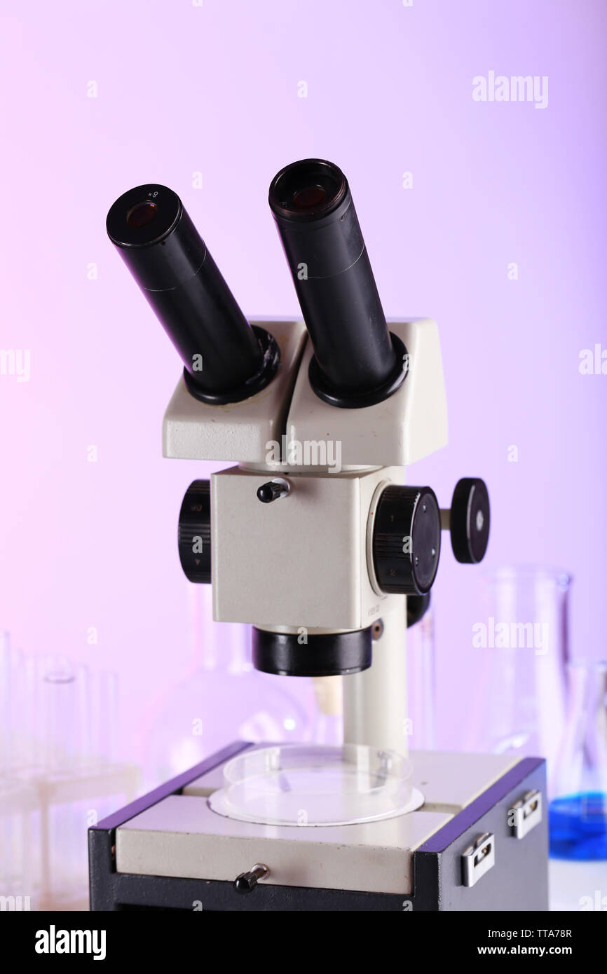 Test tubes and microscope on bright background Stock Photo - Alamy