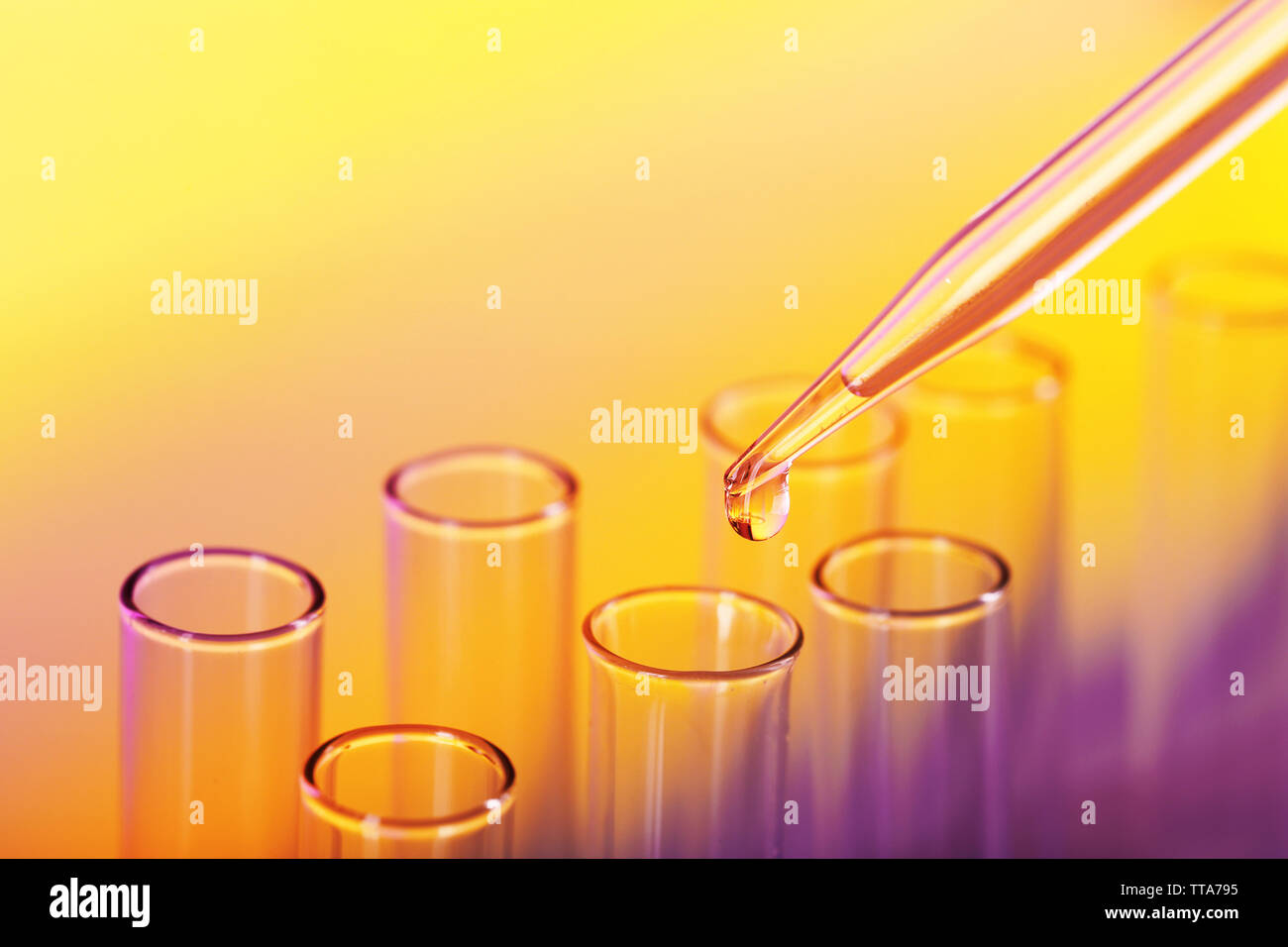 Test tubes on color background Stock Photo - Alamy