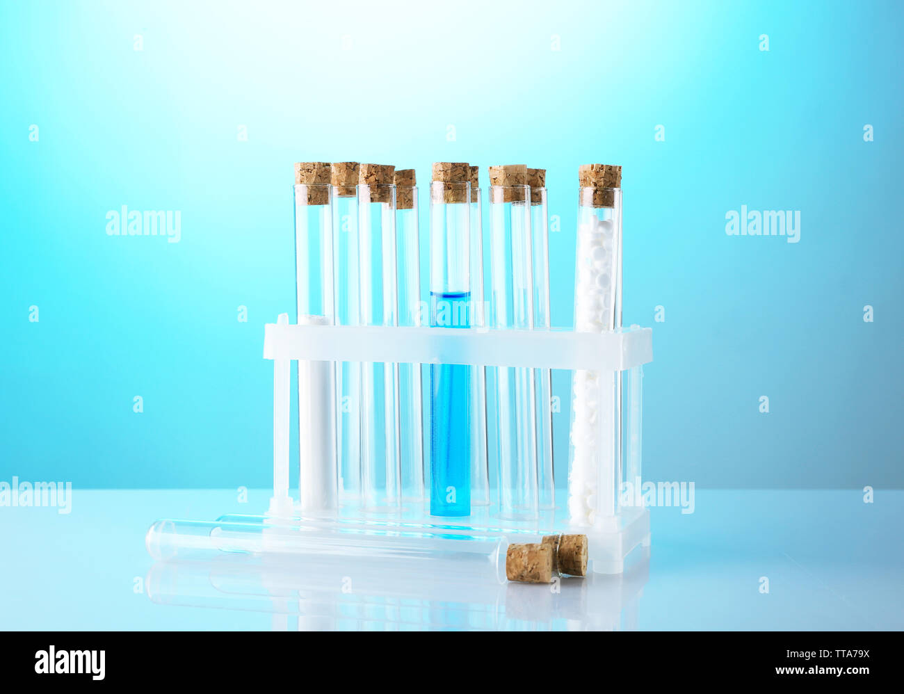 Empty laboratory test tubes on blue background Stock Photo - Alamy