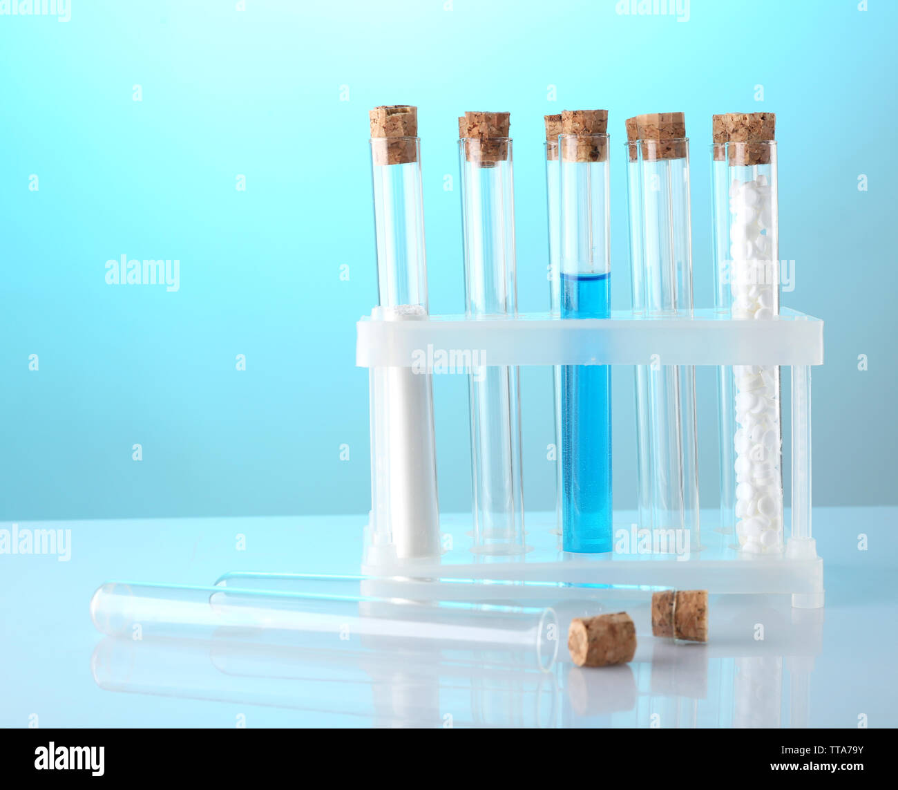 Empty laboratory test tubes on blue background Stock Photo - Alamy
