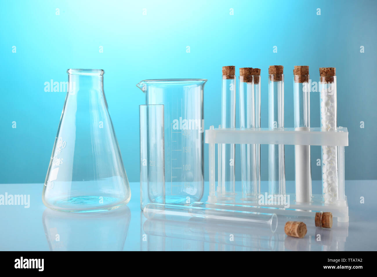Empty laboratory test tubes on blue background Stock Photo - Alamy