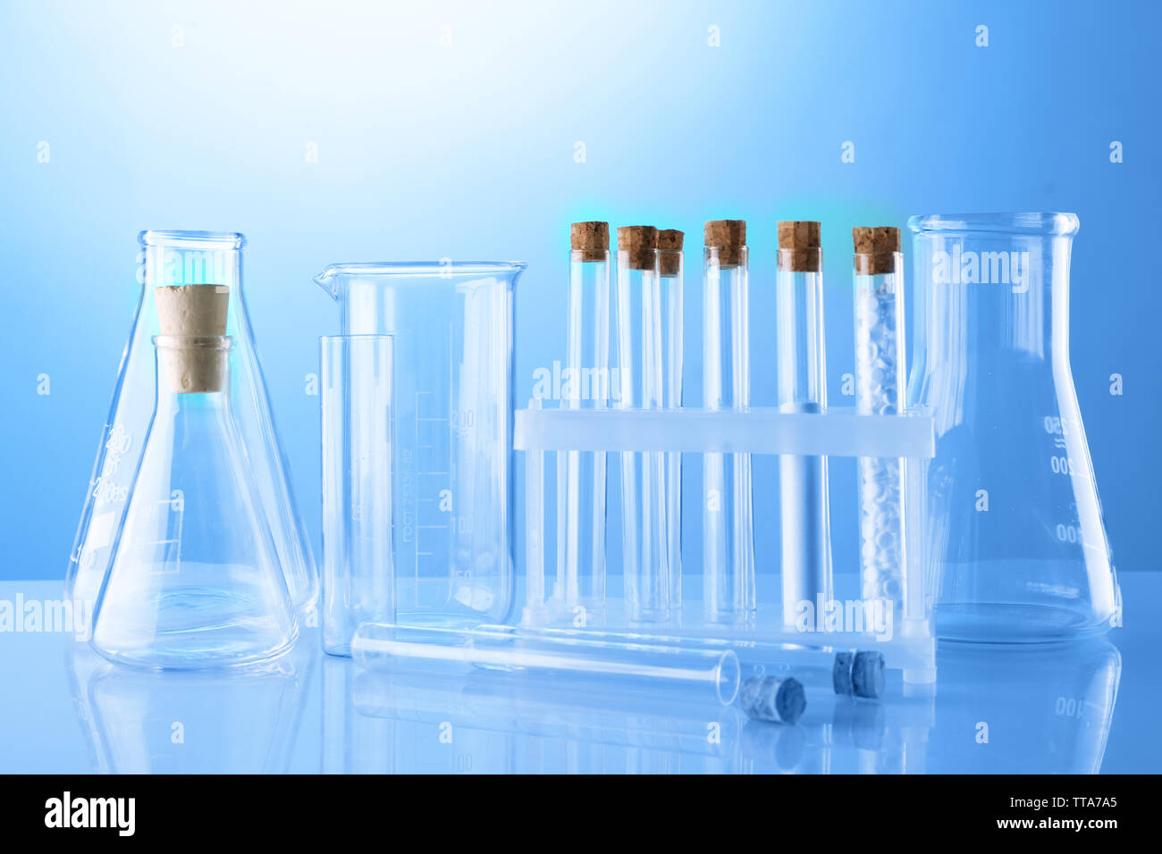 Empty laboratory test tubes on blue background Stock Photo - Alamy