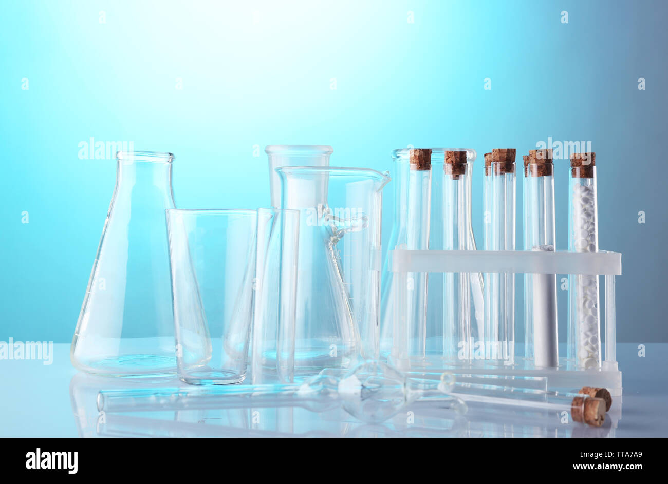 Empty laboratory test tubes on blue background Stock Photo - Alamy
