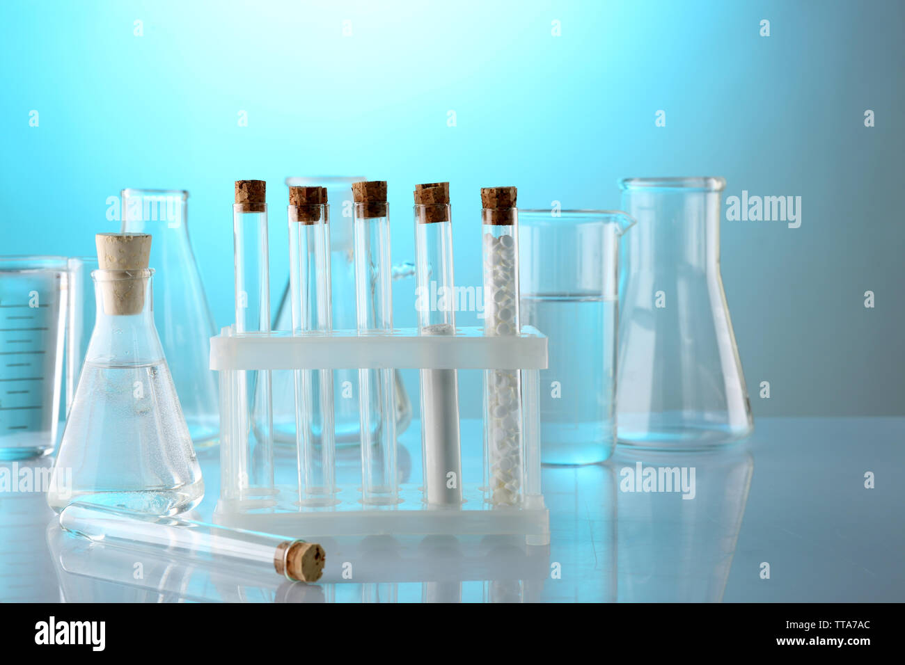 Empty laboratory test tubes on blue background Stock Photo - Alamy