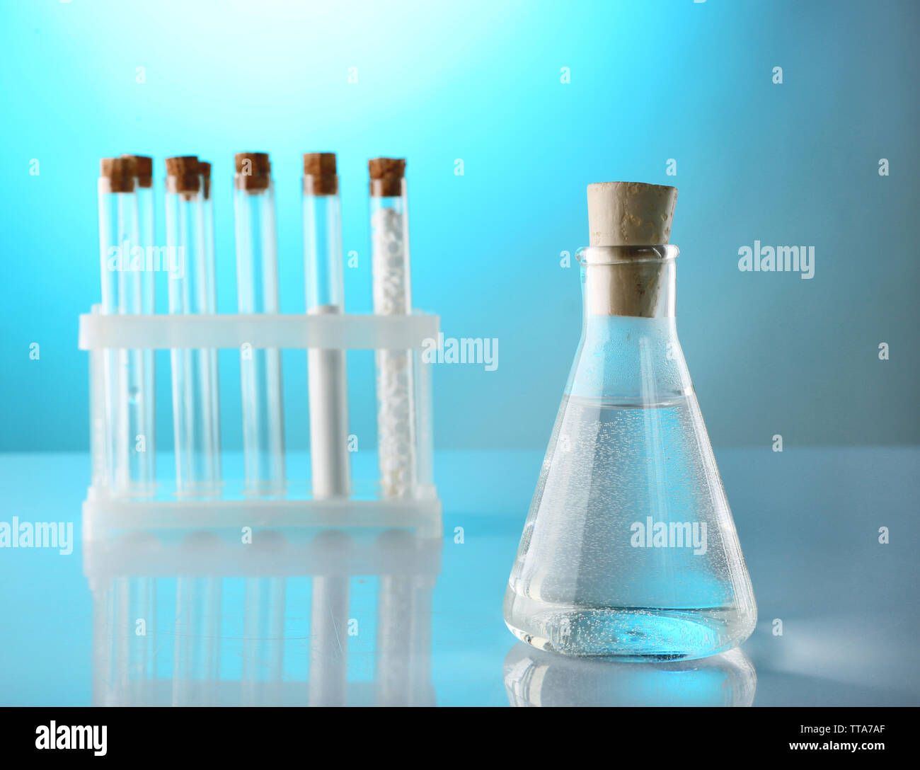 Empty laboratory test tubes on blue background Stock Photo - Alamy