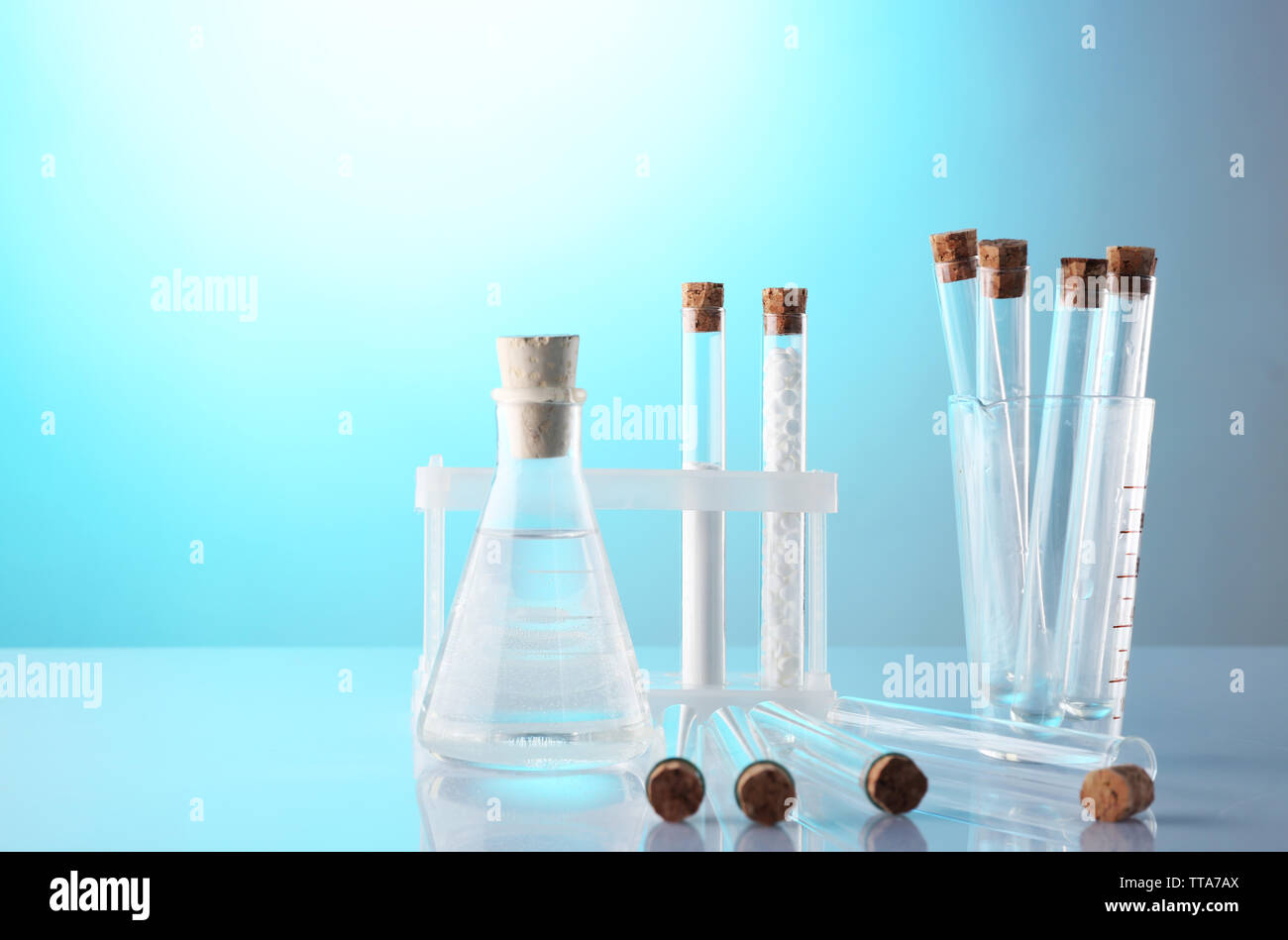 Empty laboratory test tubes on blue background Stock Photo - Alamy
