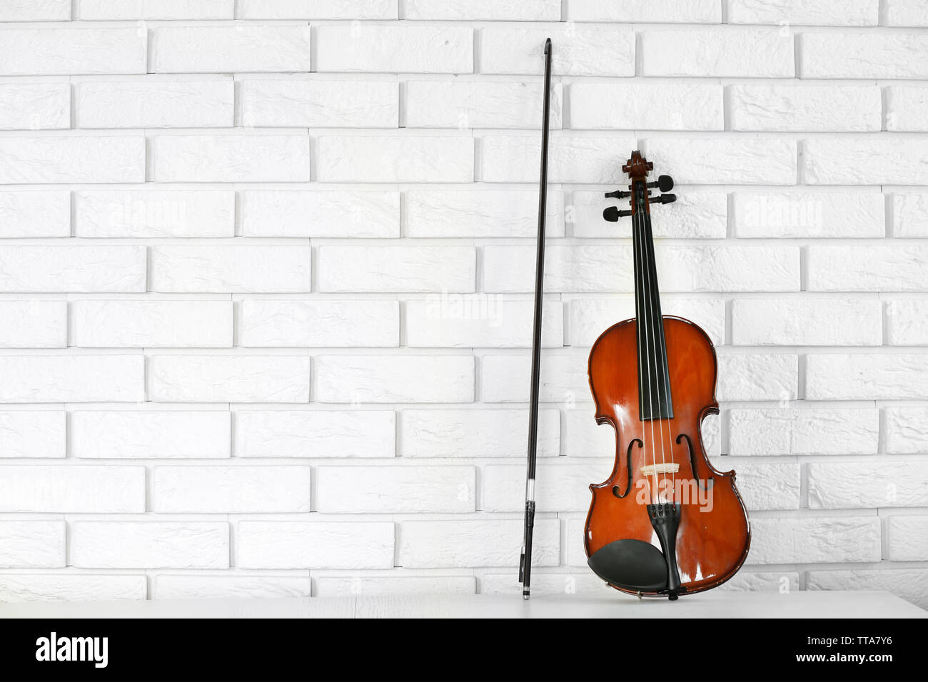 Violin on bricks wall background Stock Photo - Alamy