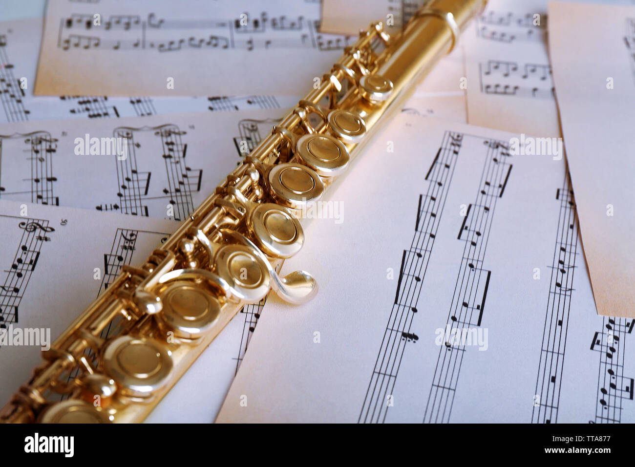 Flute on music notes background Stock Photo - Alamy