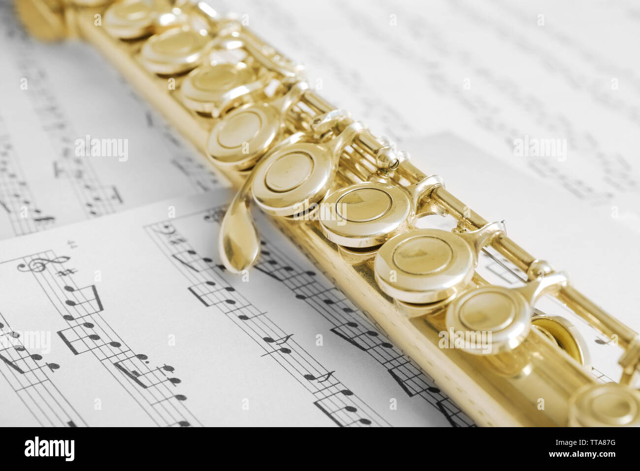 Flute on music notes background Stock Photo - Alamy