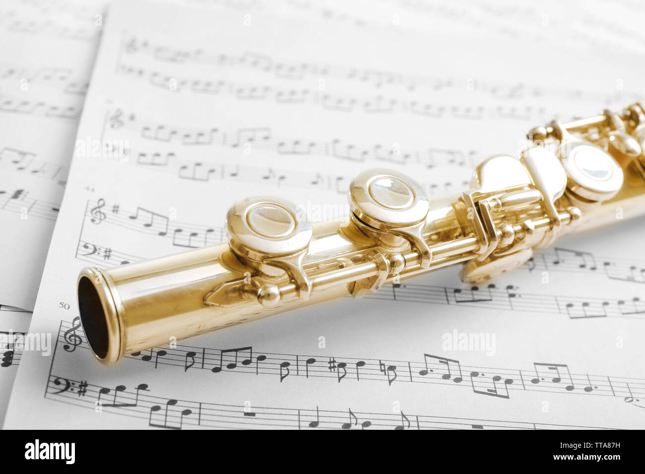 Flute on music notes background Stock Photo - Alamy