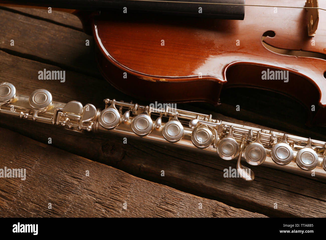 Flute with violin on table close up Stock Photo - Alamy