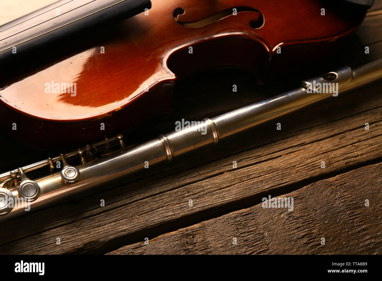 Flute with violin on table close up Stock Photo - Alamy
