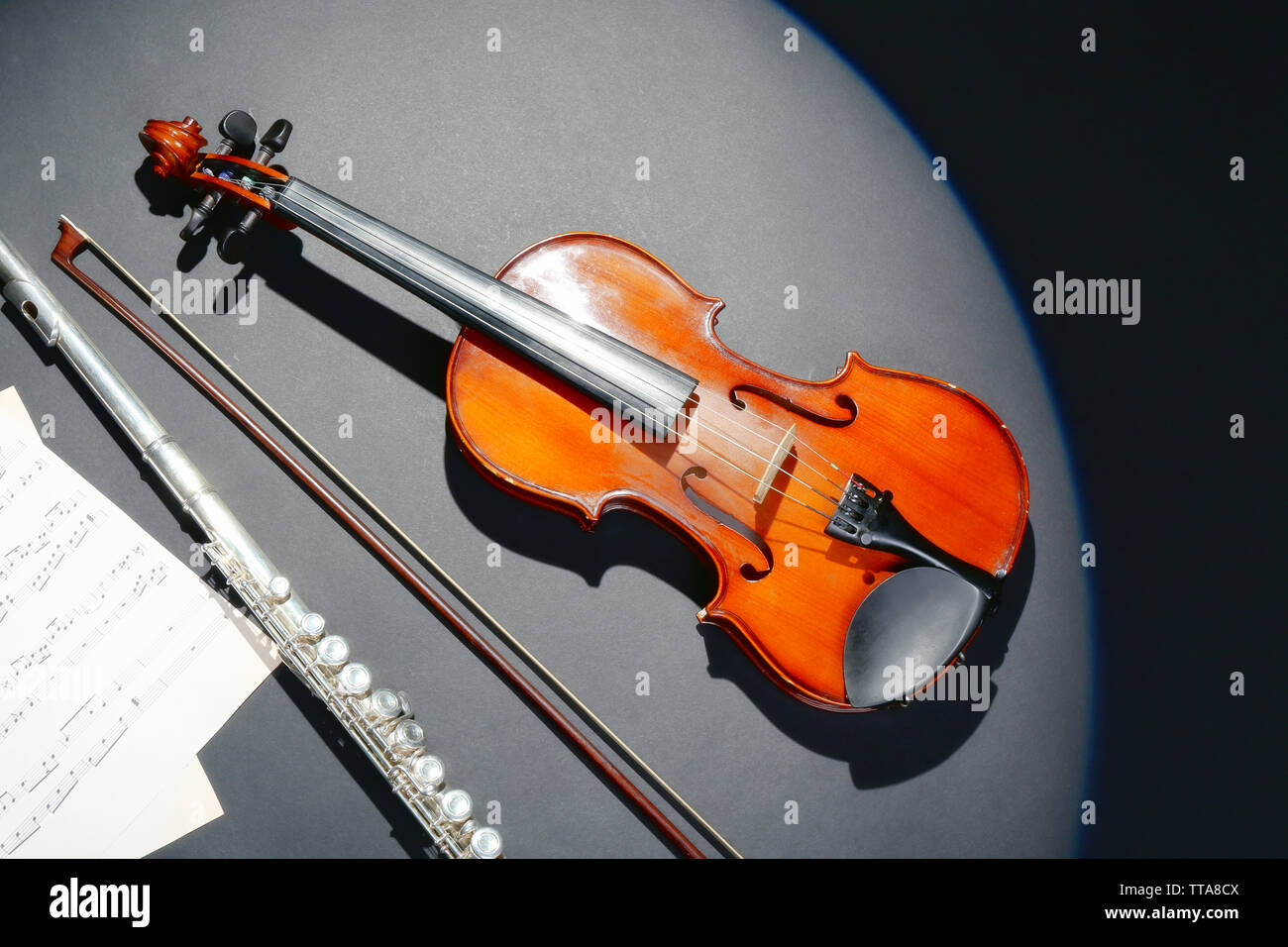 Violin and flute with music notes on dark background Stock Photo - Alamy