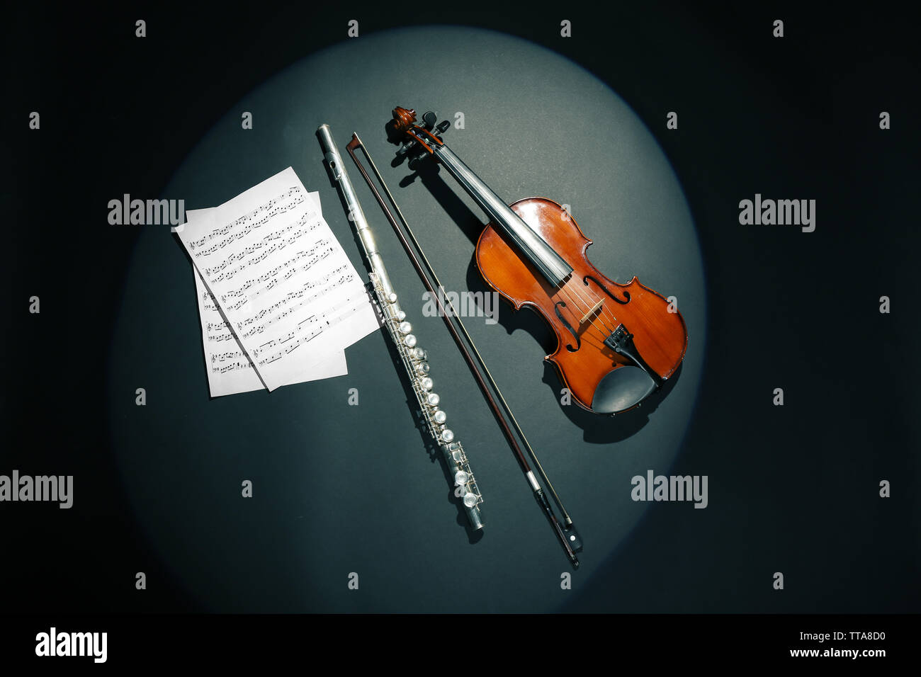 Violin and flute with music notes on dark background Stock Photo - Alamy