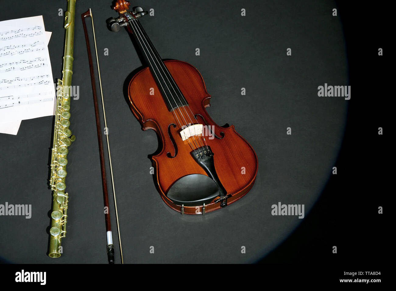 Violin and flute with music notes on dark background Stock Photo - Alamy