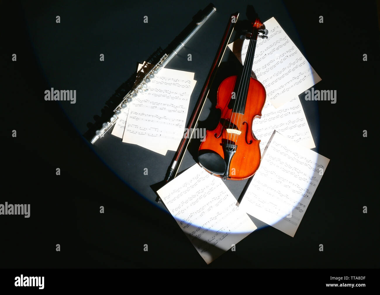 Violin and flute with music notes on dark background Stock Photo - Alamy