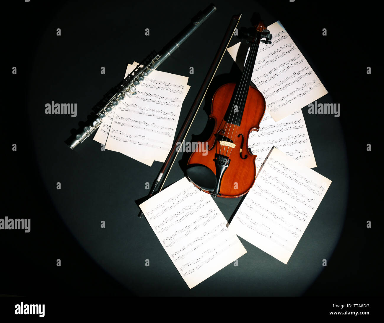 Violin and flute with music notes on dark background Stock Photo - Alamy