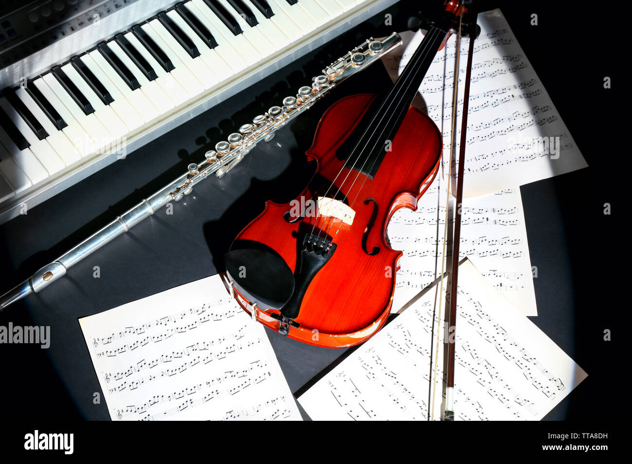 Musical instruments with music notes on dark background Stock Photo - Alamy