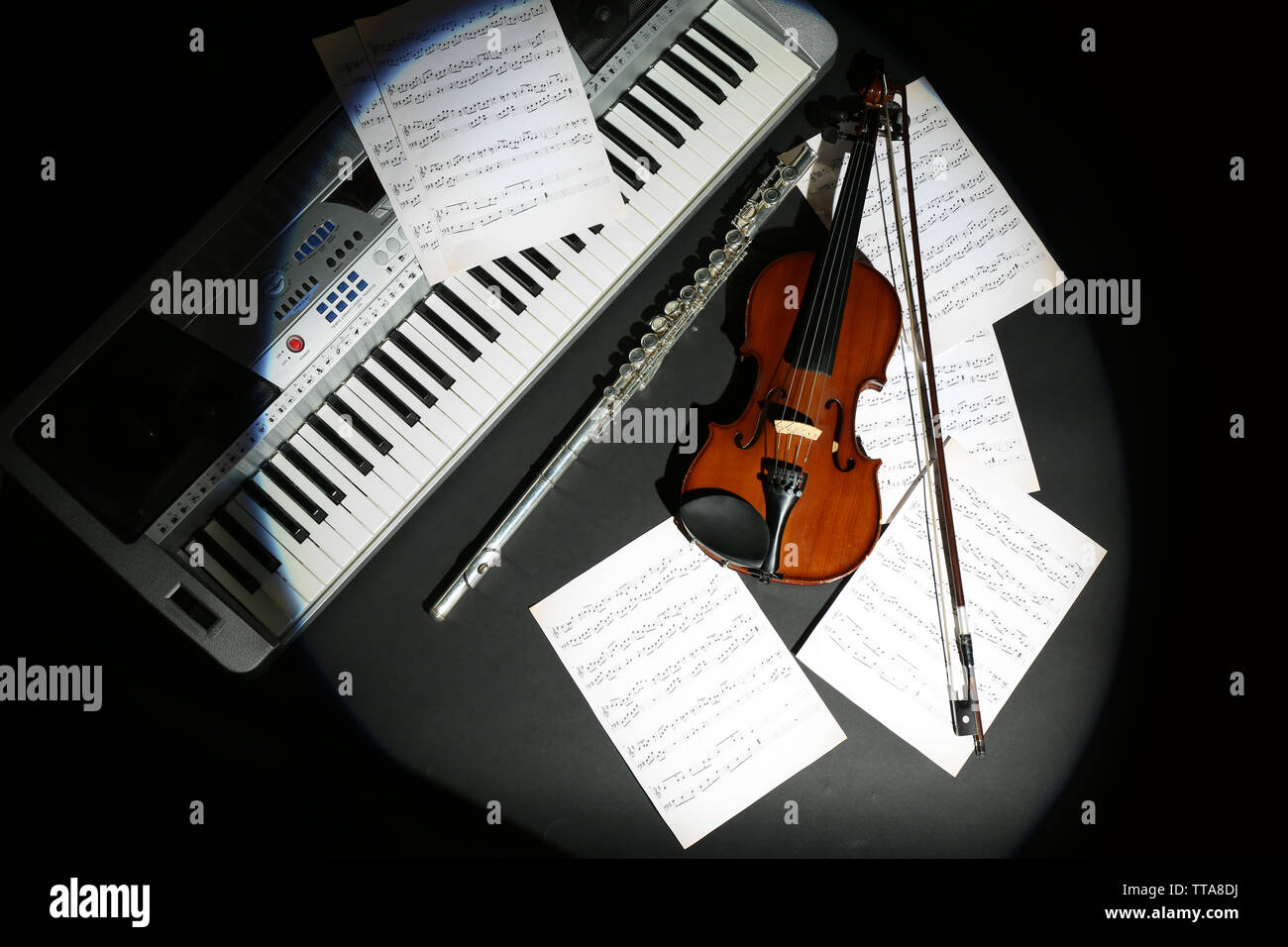 Musical instruments with music notes on dark background Stock Photo - Alamy