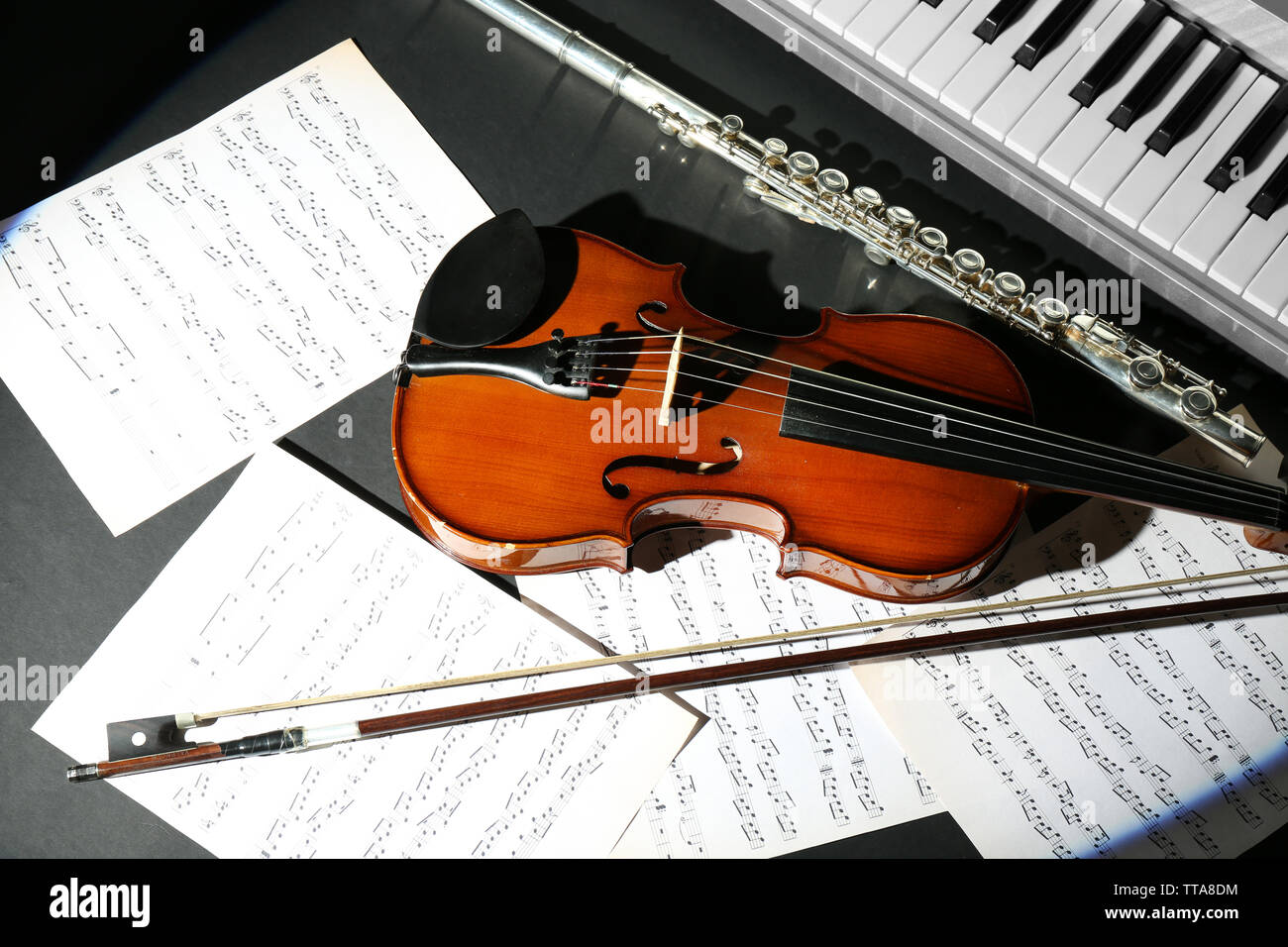 Musical instruments with music notes on dark background Stock Photo - Alamy