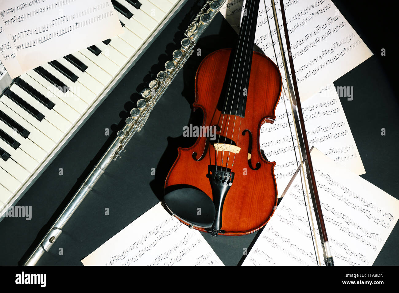 Musical instruments with music notes on dark background Stock Photo - Alamy