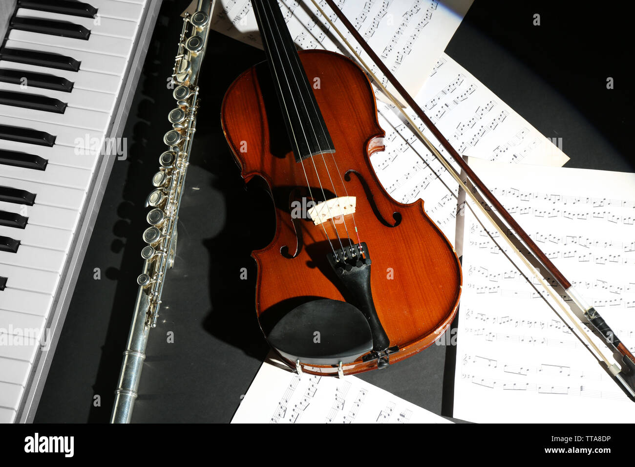 Musical instruments with music notes on dark background Stock Photo - Alamy