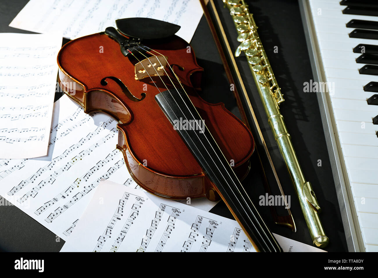 Musical instruments with music notes on dark background Stock Photo - Alamy