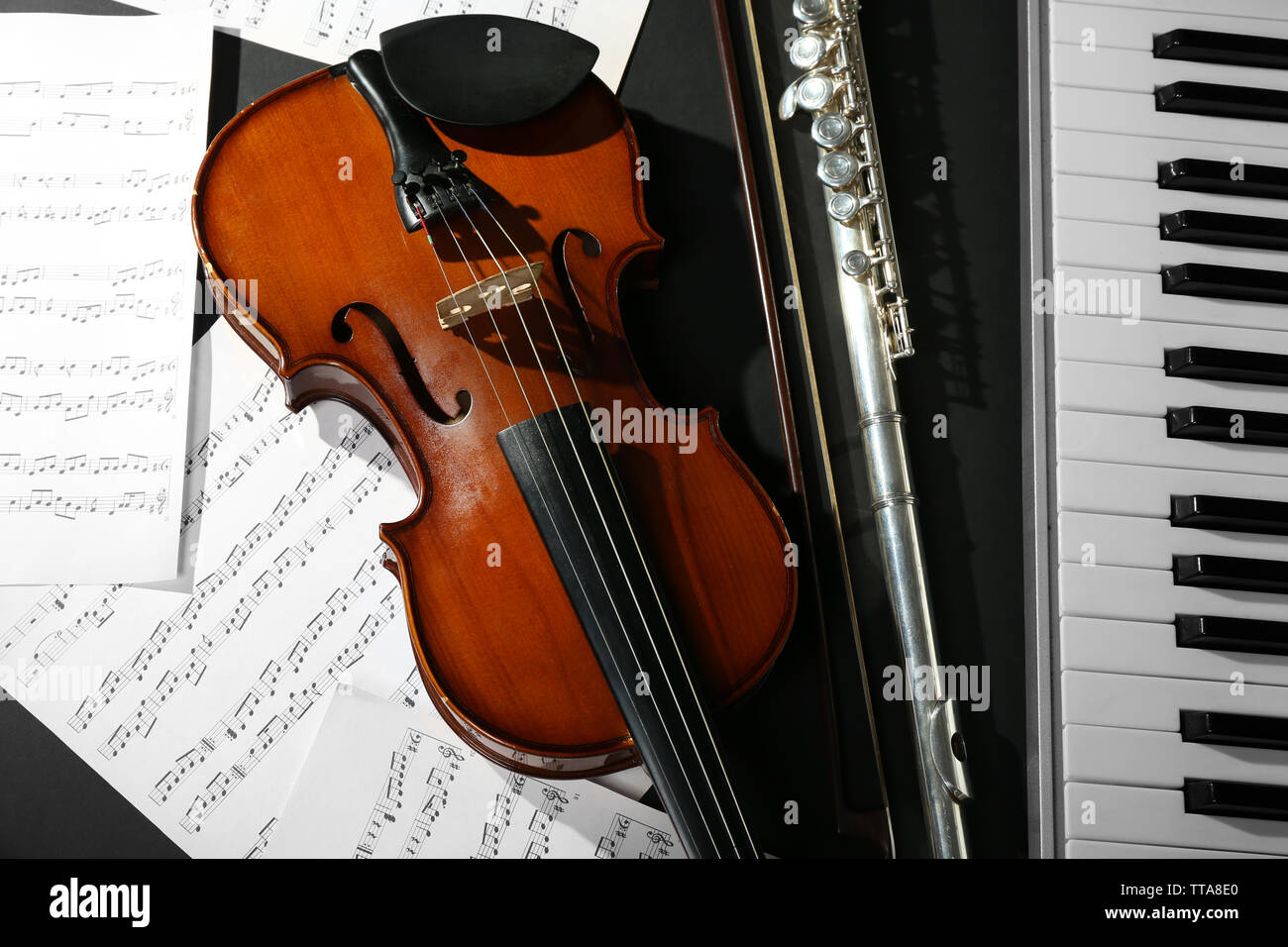 Musical instruments with music notes on dark background Stock Photo - Alamy