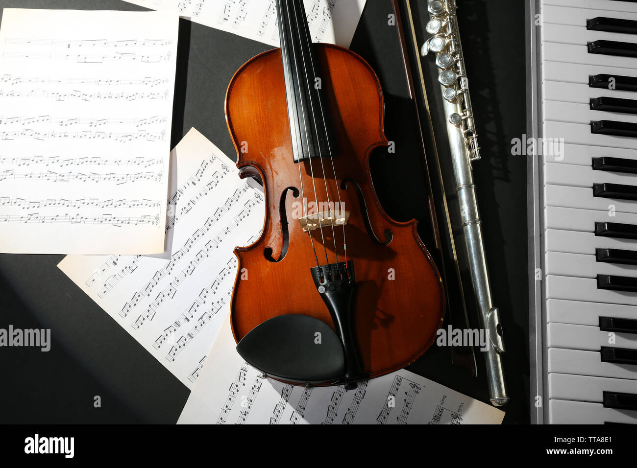Musical instruments with music notes on dark background Stock Photo - Alamy