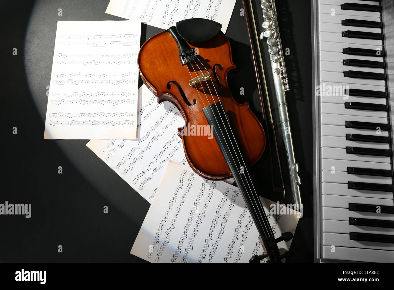 Musical instruments with music notes on dark background Stock Photo - Alamy