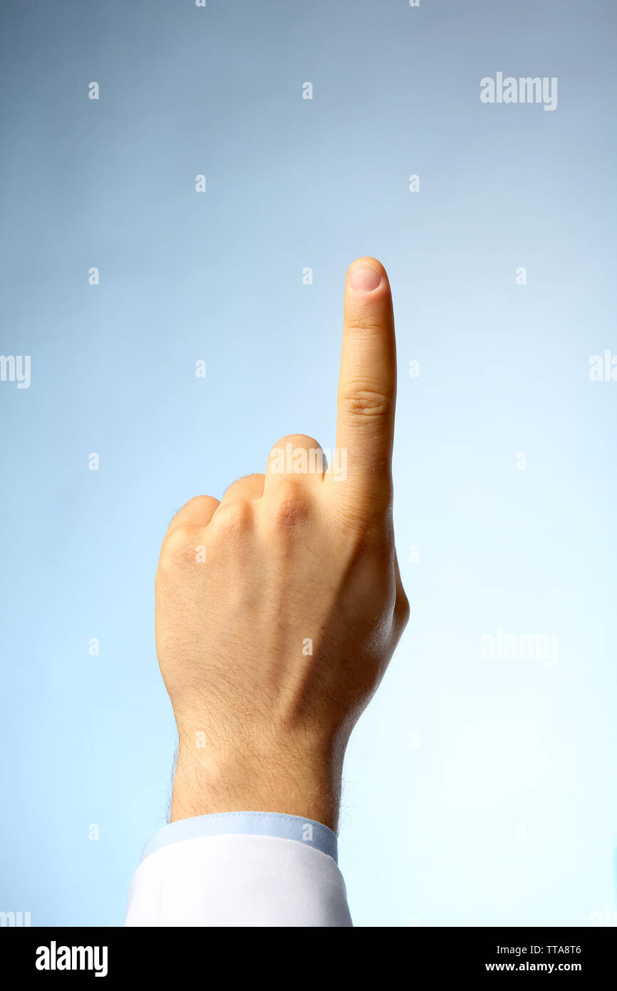 Doctor hand showing sign on blue background Stock Photo - Alamy