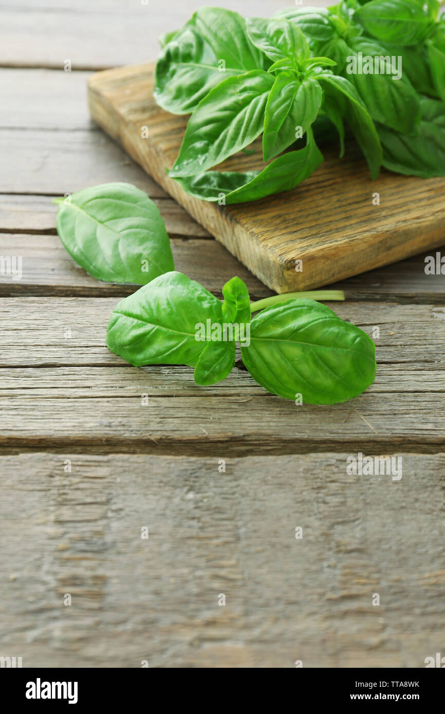Green fresh basil on wooden background Stock Photo - Alamy