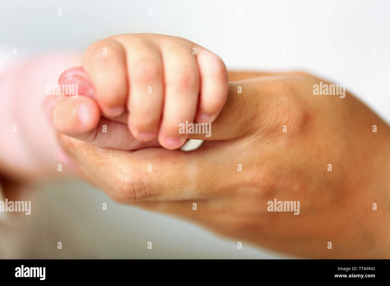Adult and baby hands, closeup Stock Photo - Alamy