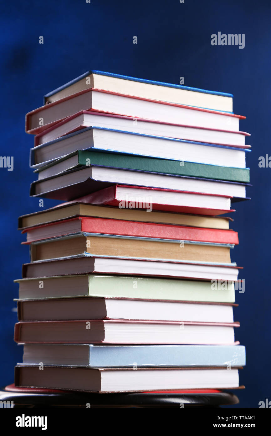 Stack of books on blackboard background Stock Photo - Alamy