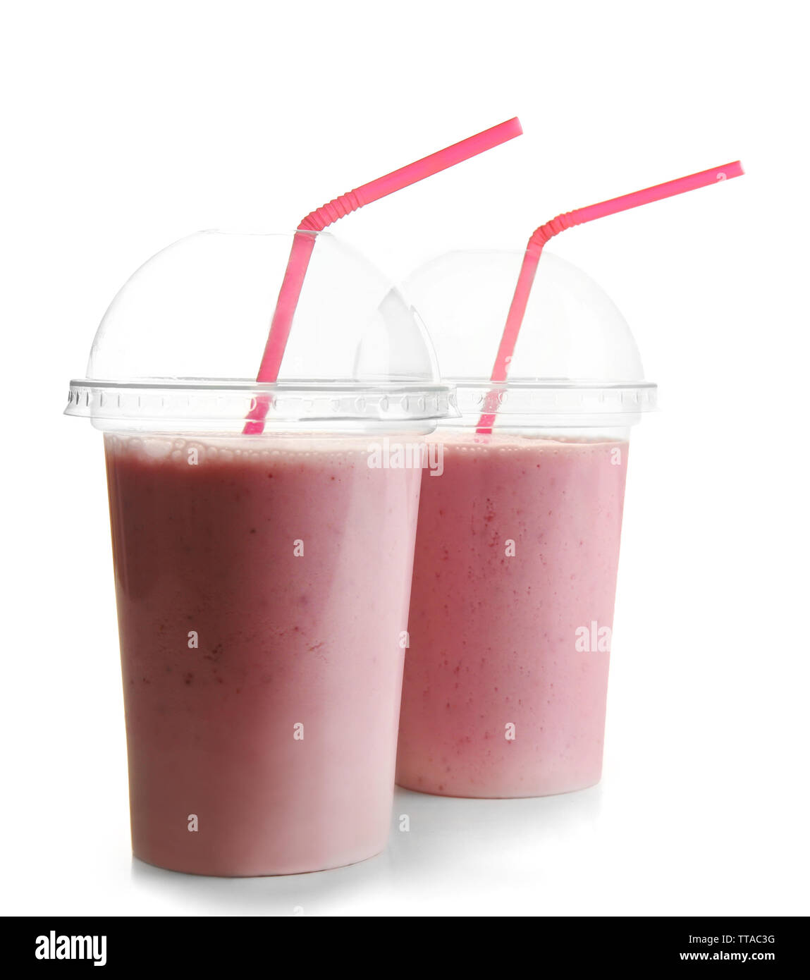 Plastic cups of milkshake with strawberries isolated on white Stock ...