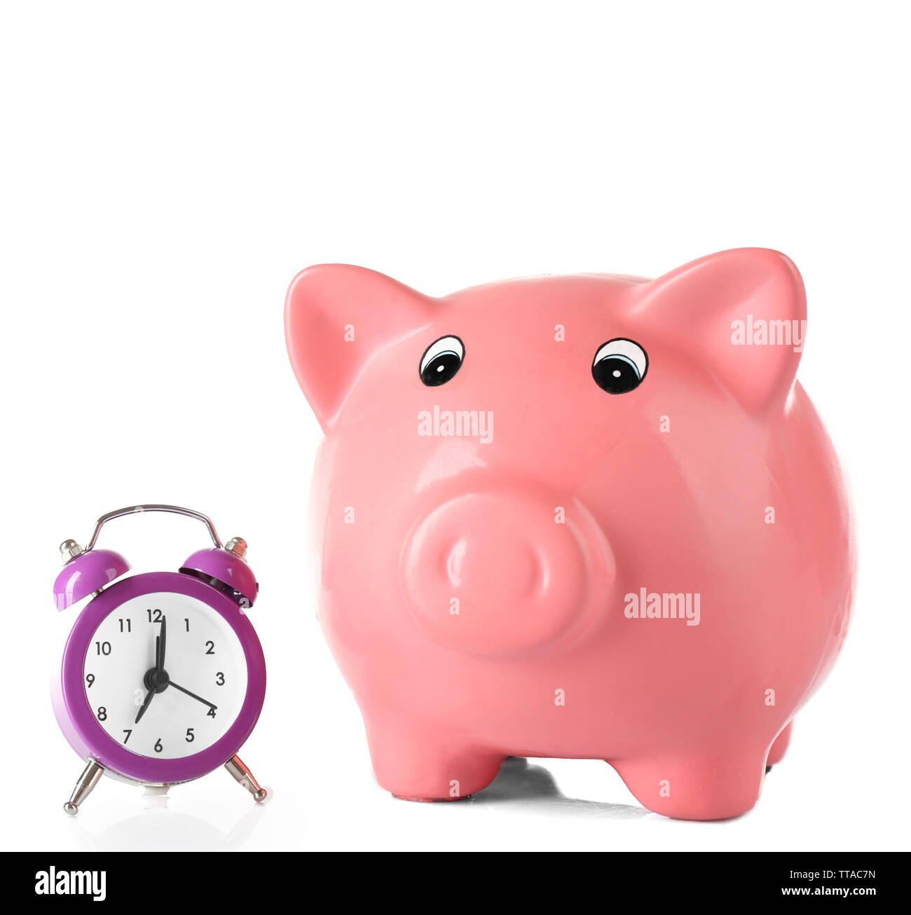 Piggy bank with alarm clock isolated on white Stock Photo - Alamy