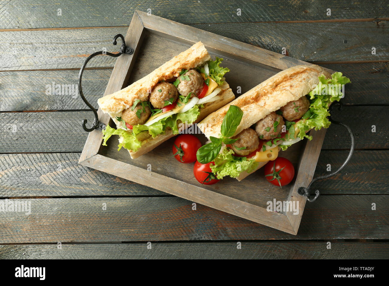 Homemade Spicy Meatball Sub Sandwich on tray, on wooden table ...