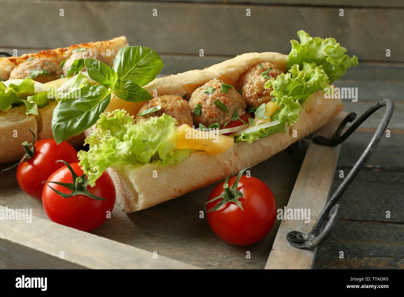 Homemade Spicy Meatball Sub Sandwich on tray, on wooden table ...