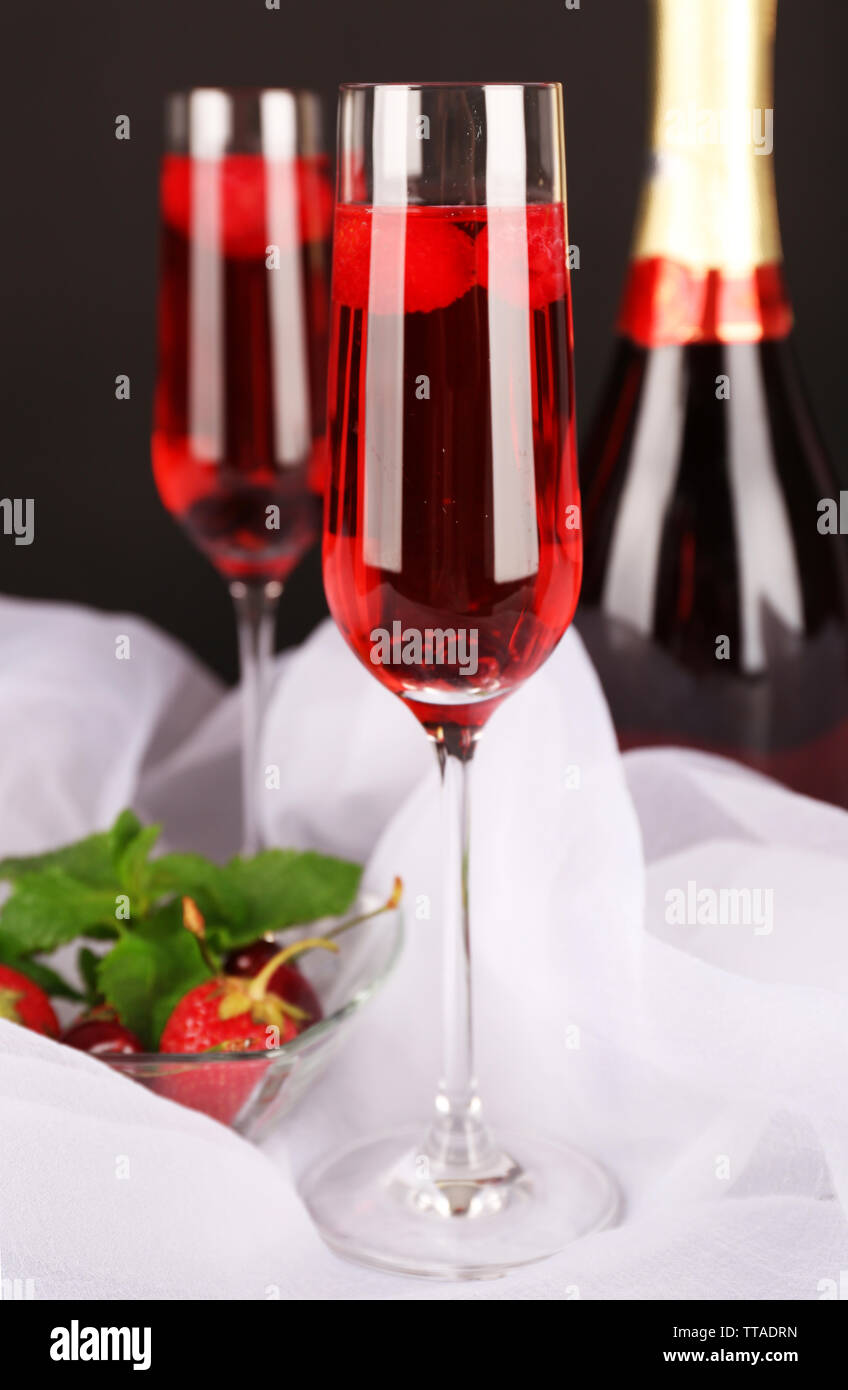 Glasses of champagne with berries on black background Stock Photo - Alamy