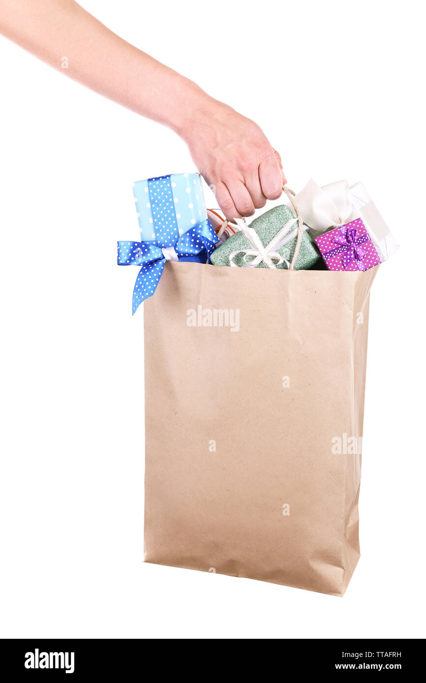 Female hand holding paper bag with present boxes isolated on white ...