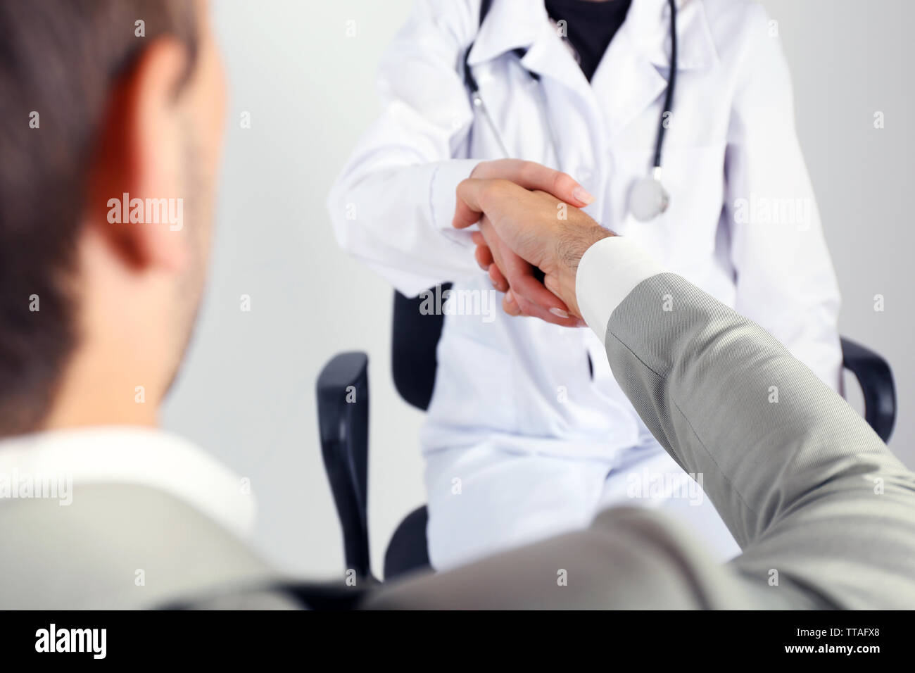 Doctor receiving patient in office Stock Photo - Alamy