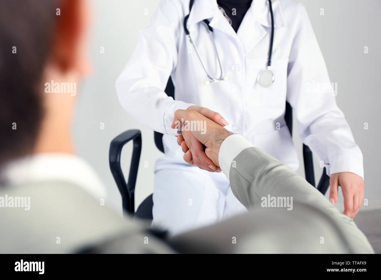 Doctor receiving patient in office Stock Photo - Alamy