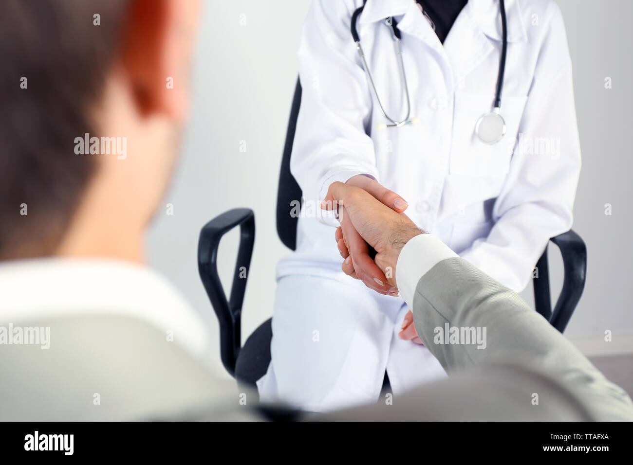 Doctor receiving patient in office Stock Photo - Alamy