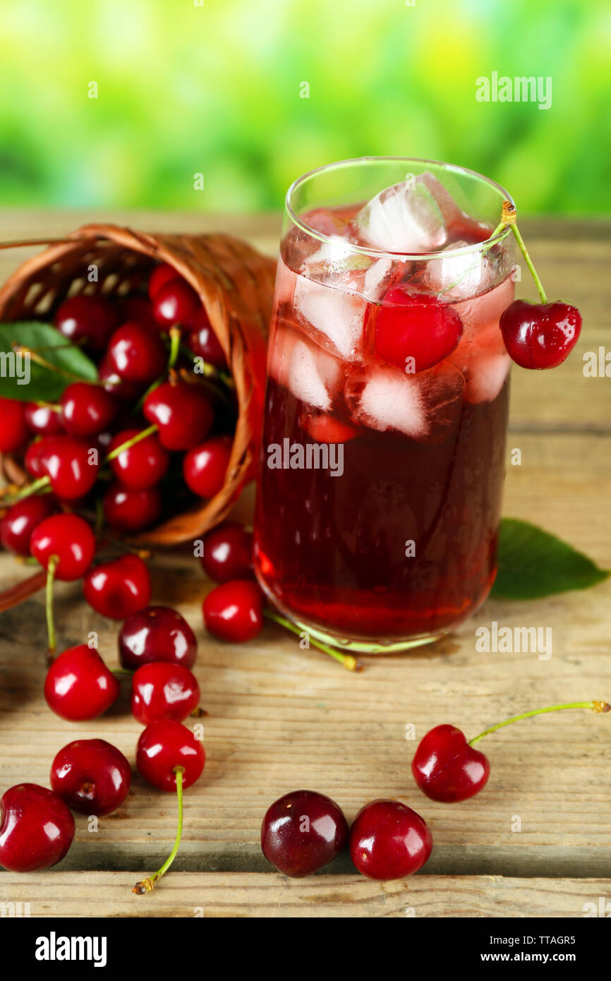Glass of fresh juice with cherries on wooden table close up Stock Photo ...