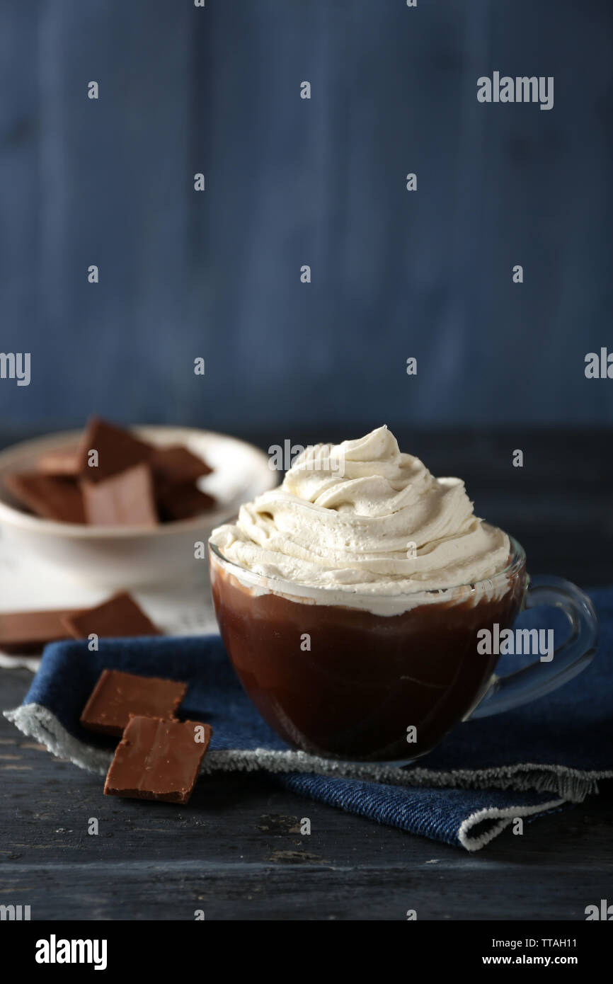 Cup of coffee with cream on color wooden background Stock Photo - Alamy