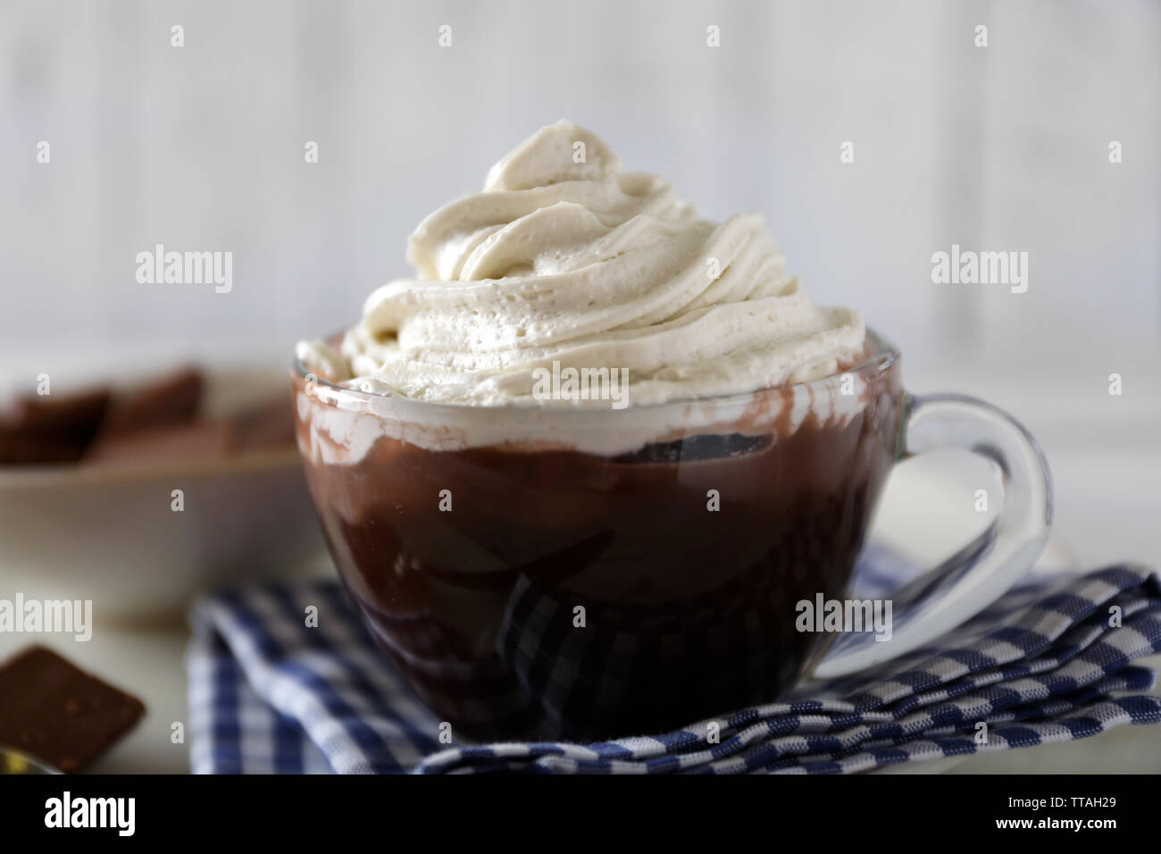 Cup of coffee with cream on color wooden background Stock Photo - Alamy